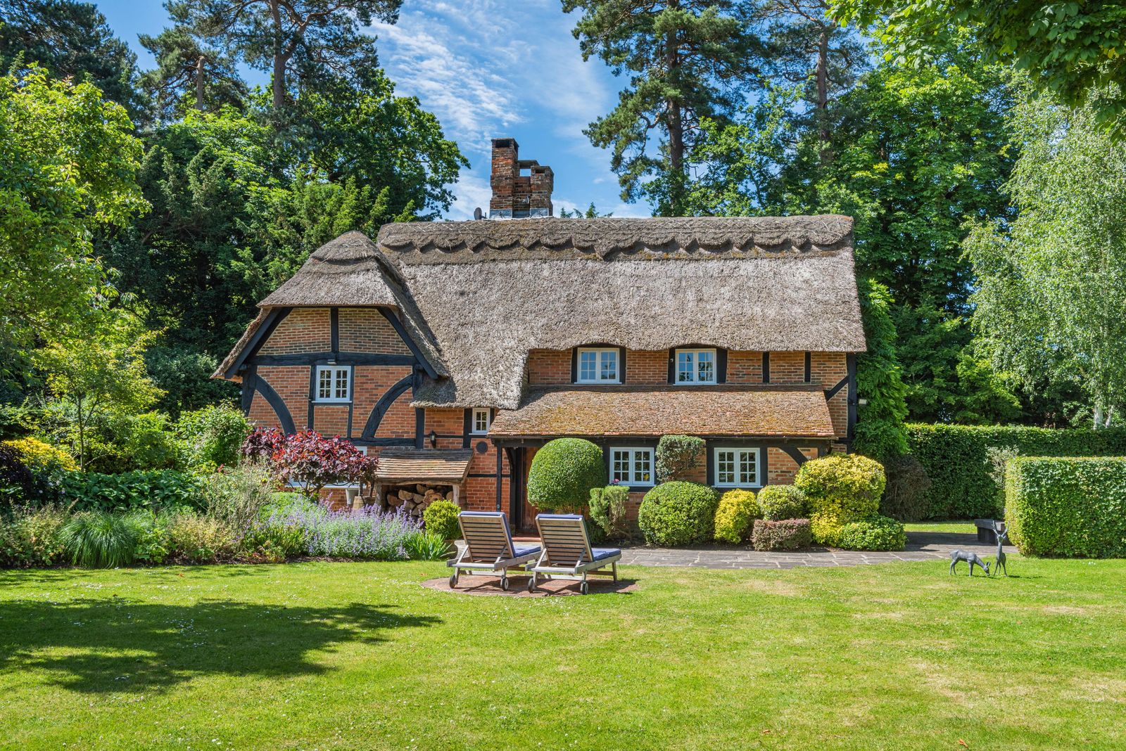 A billionaire's thatched cottage is for sale in Surrey, once owned by ...