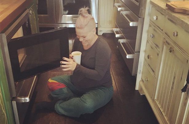 Picture of pregnant singer Pink drinking coffee in front of a microwave ...