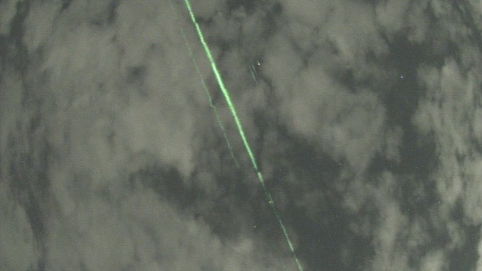 Mysterious green lasers caught on camera belong to NASA satellite ...