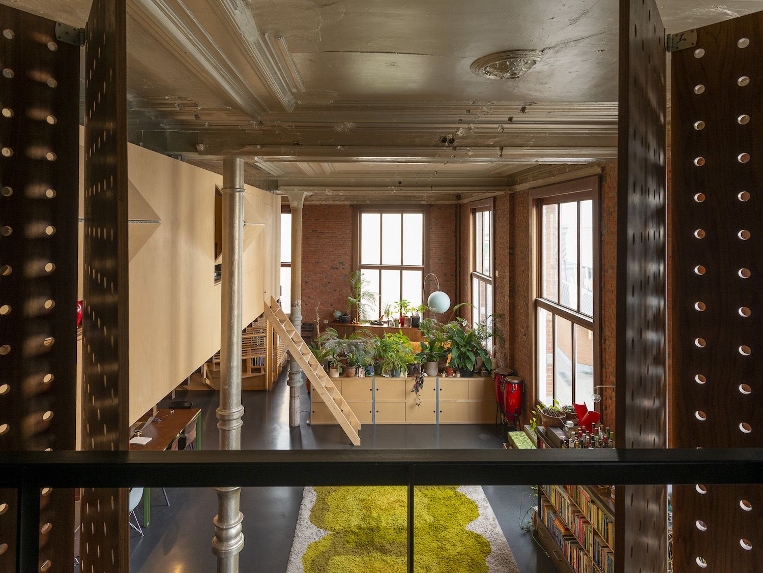 Explore a double height loft in Antwerp with suspended mezzanine