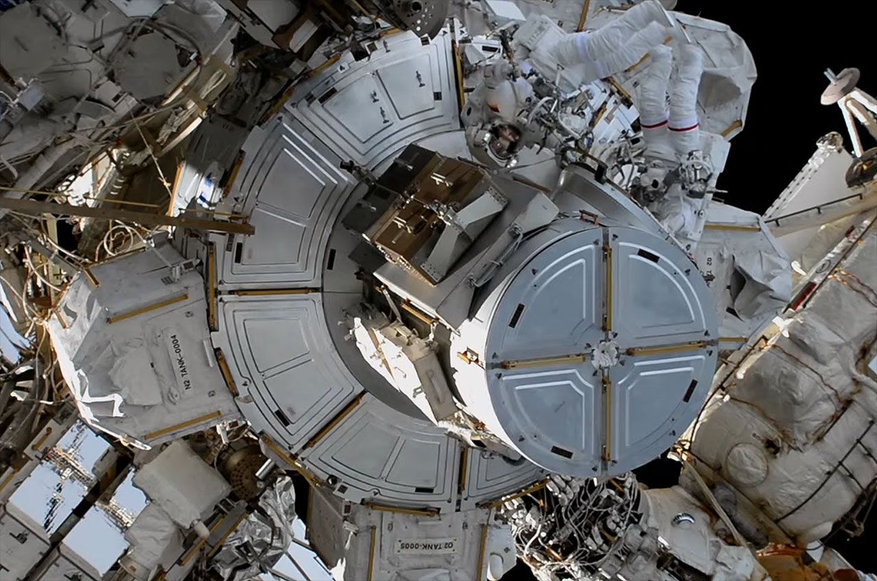 Spacewalking astronauts restore radiator, replace space station camera ...