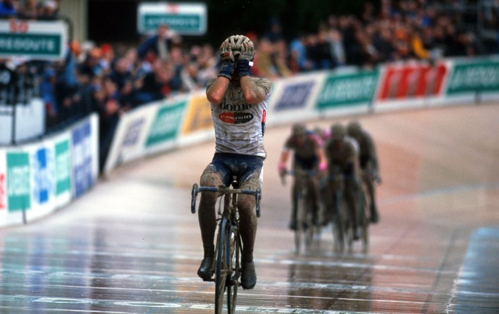 A mud-bath, an over-inflated spare tyre, and a domestique holding the ...