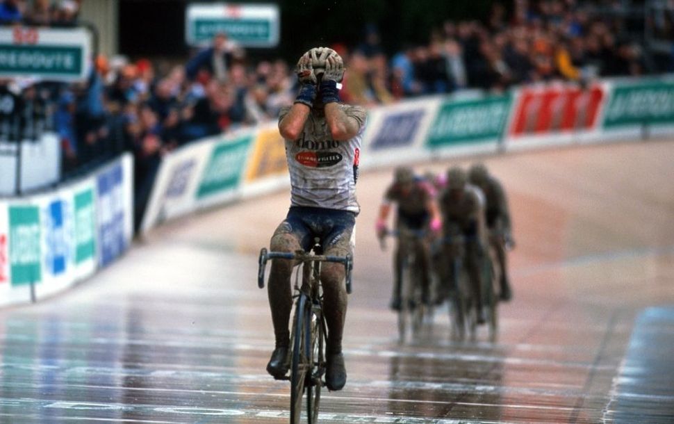 A mud-bath, an over-inflated spare tyre, and a domestique holding the ...