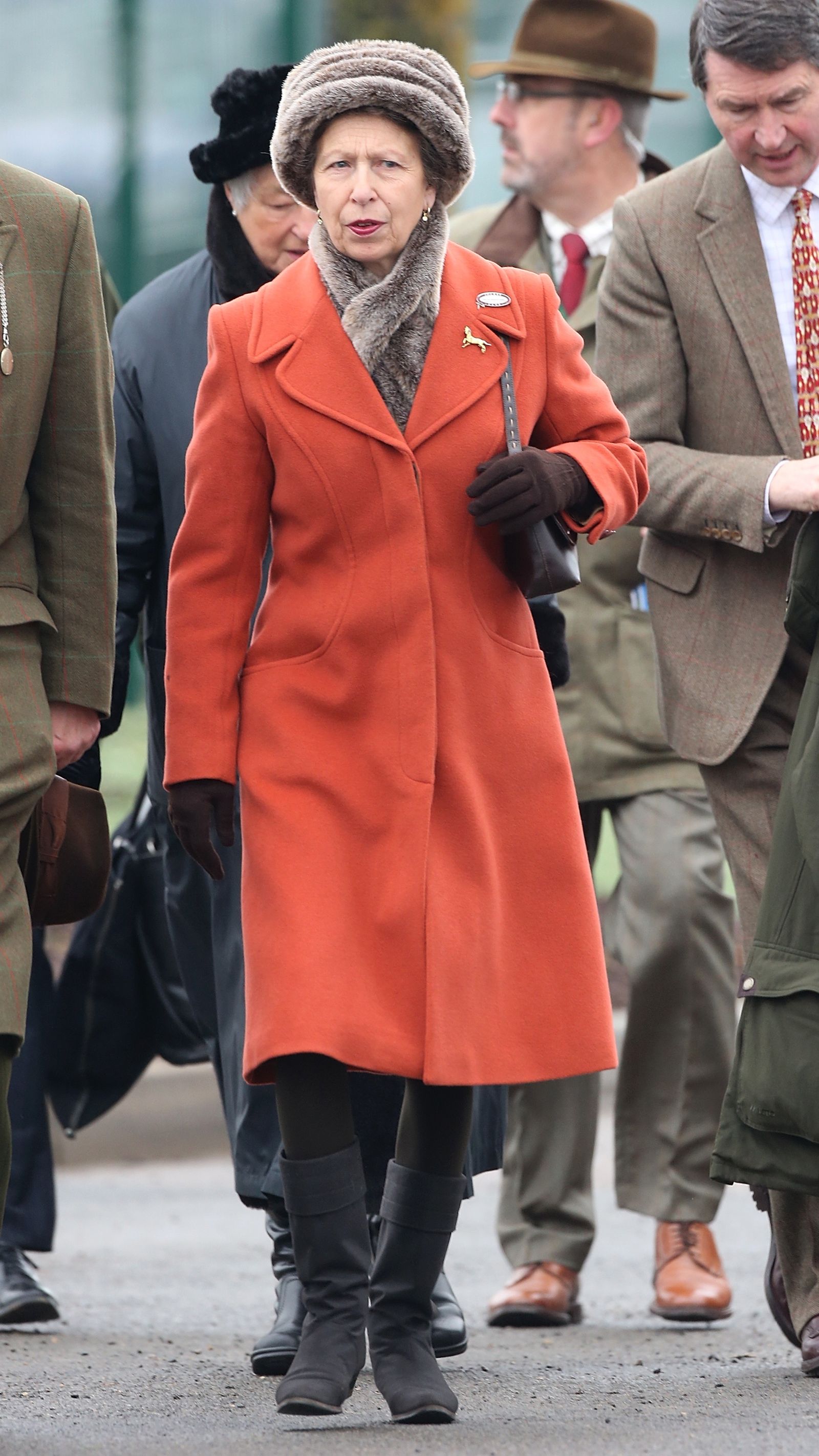 Princess Anne wrapped up in burnt orange coat, fluffy hat and boots ...