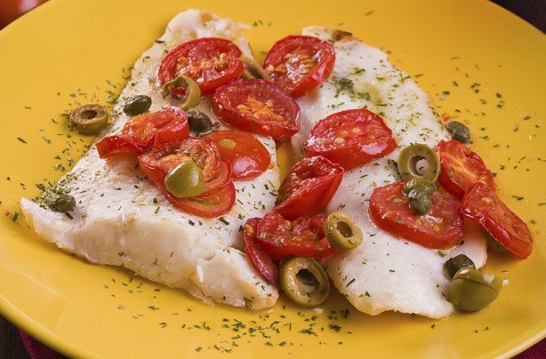 Paper-wrapped fish with cherry tomatoes and olives Recipes | GoodtoKnow
