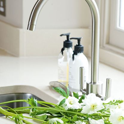 Take a tour around a sleek and glossy cream kitchen | Ideal Home