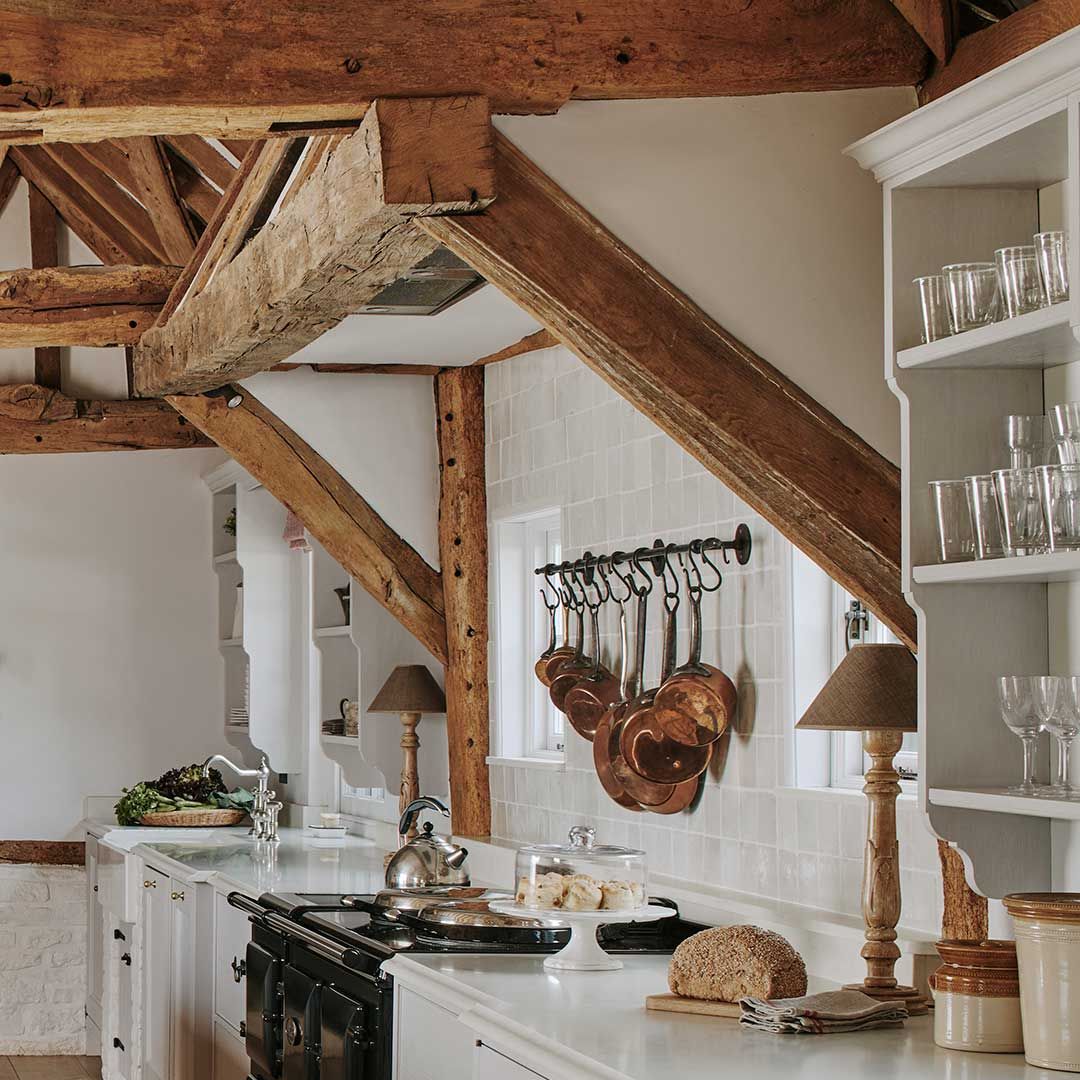 A modern kitchen perfectly framed by the exquisite ancient beams ...