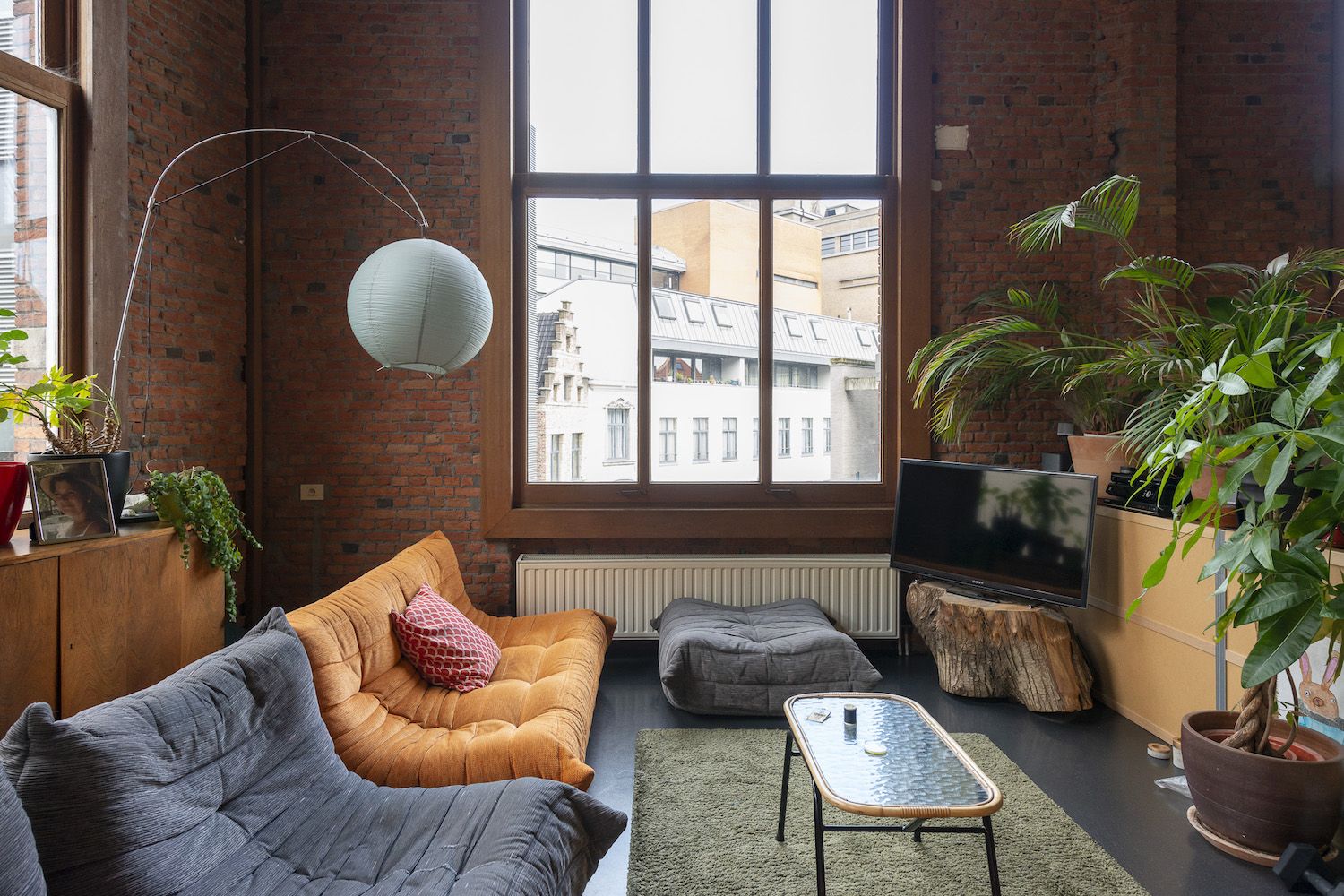 Explore a double height loft in Antwerp with suspended mezzanine