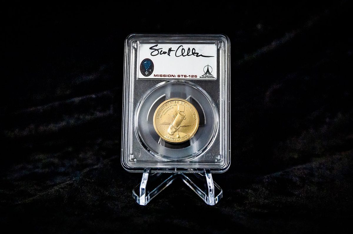 Last astronauts to visit Hubble Space Telescope sign coins for AMF ...