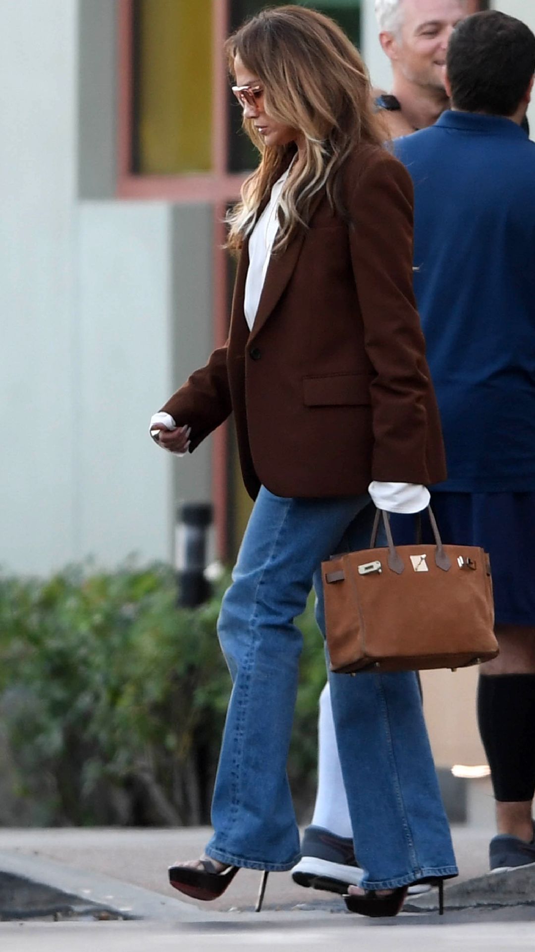 JLo is all in for fall with a chocolate brown blazer and dark blue ...