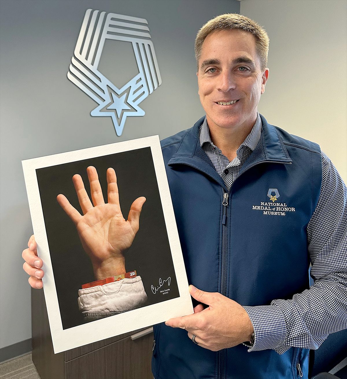 Former astronaut Chris Cassidy raises hand for My Hand My Cause photo ...