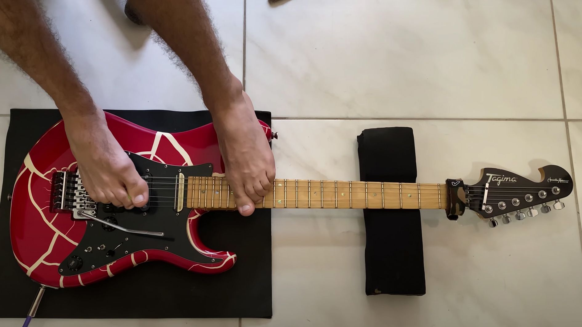 Guitarist uses his feet to play Guns N' Roses' Sweet Child O' Mine in ...