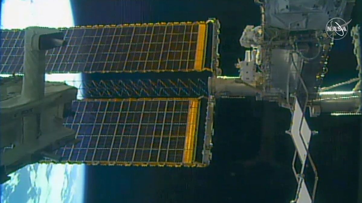 Spacewalking astronauts tackle stubborn struts to prime space station ...