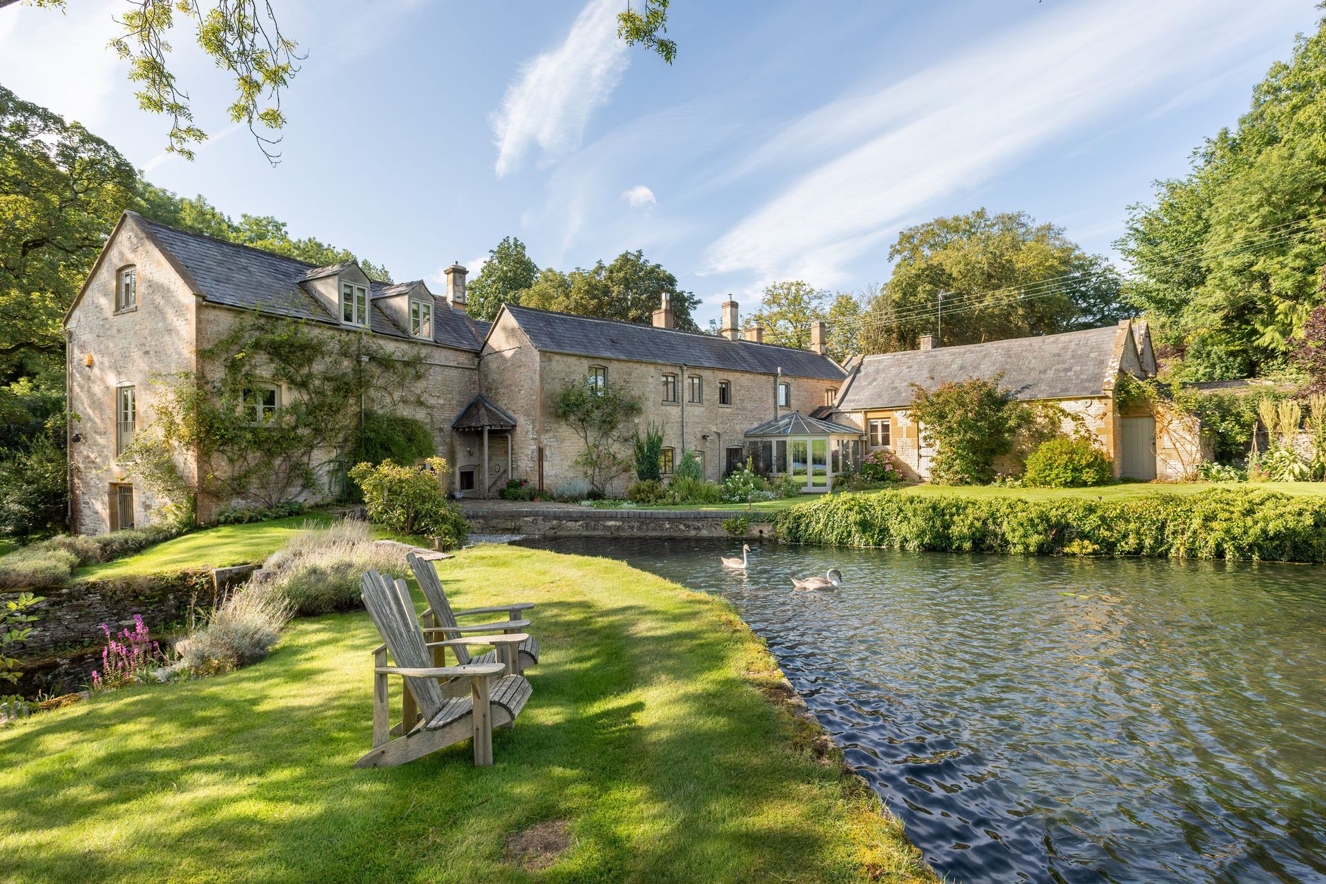 An old Cotswolds mill house with a marvellous mill pond, a two-storey ...