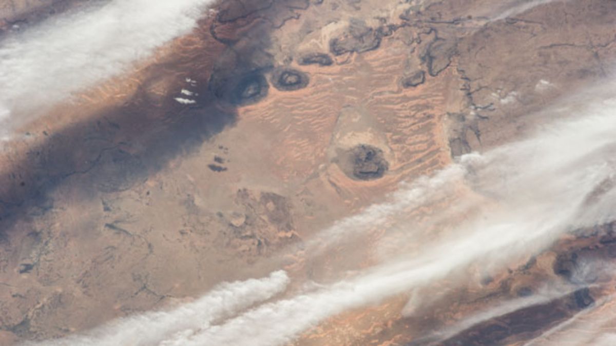 Trio of 'black mesas' leftover from Paleozoic era spawn rare sand dunes ...