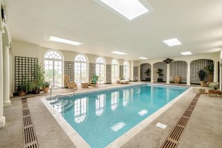 A sweeping double staircase, stone floors and oak-panelled walls meet ...