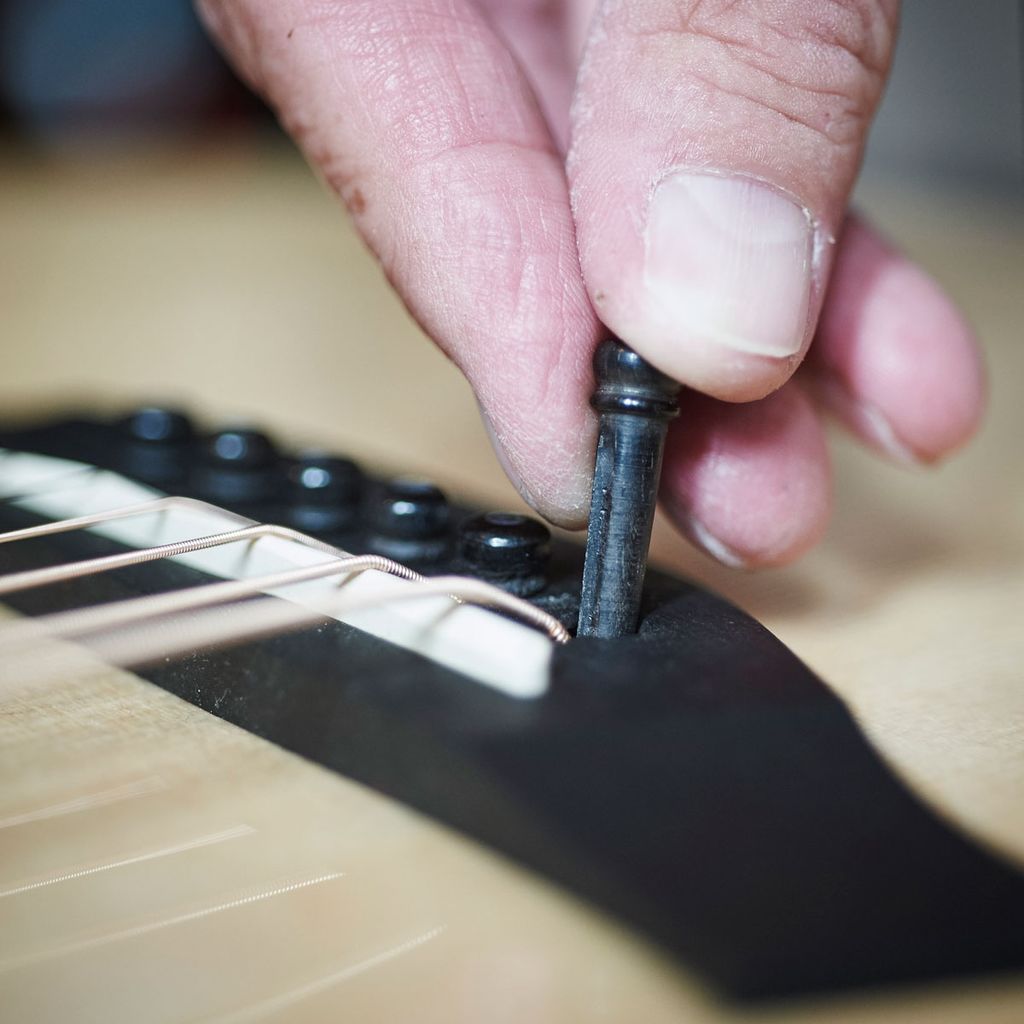 How to fix acoustic guitar saddle and bridge pin problems | Guitar World