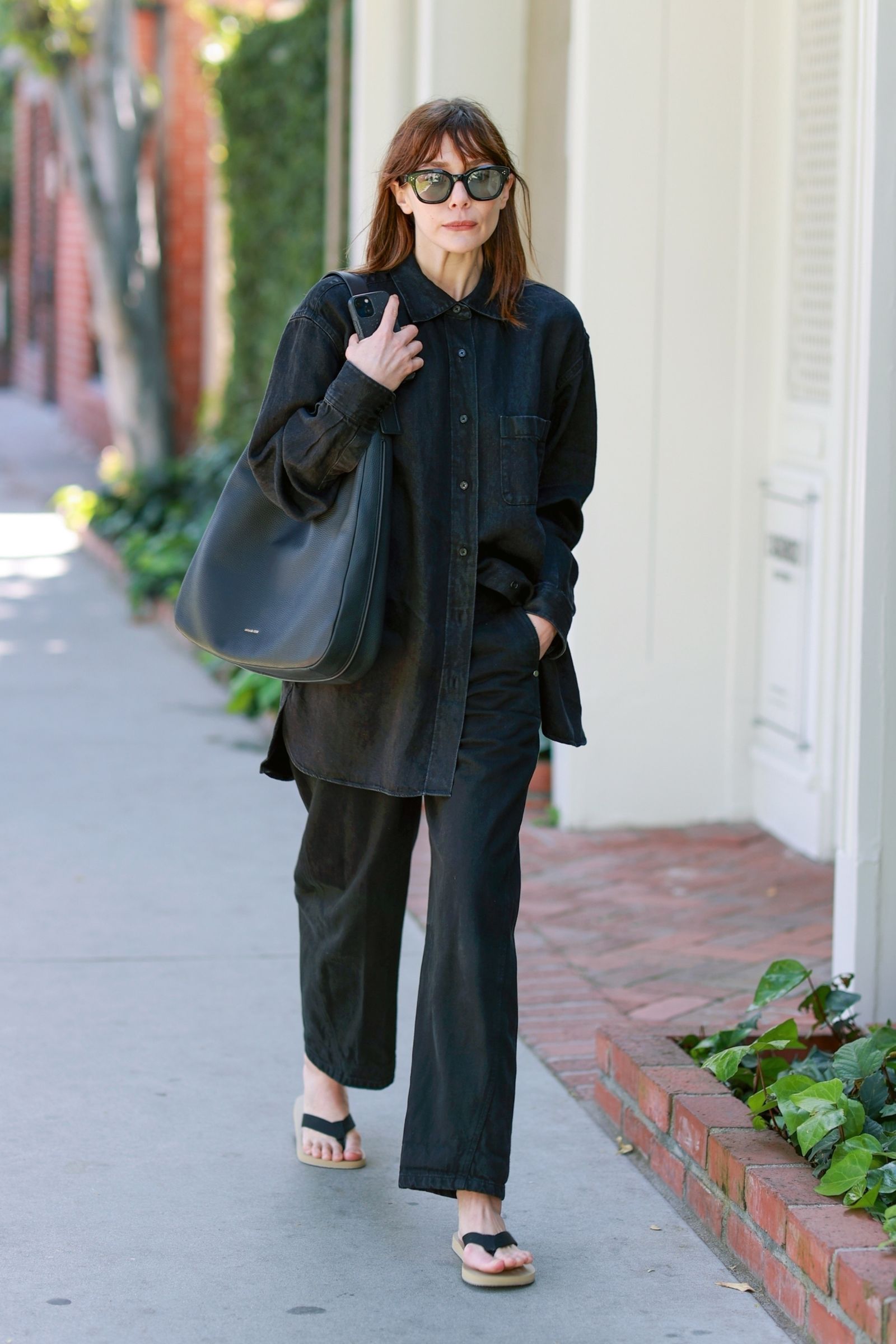 Elizabeth Olsen Wears a $1,350 Denim Shirt From The Row to Visit Her ...