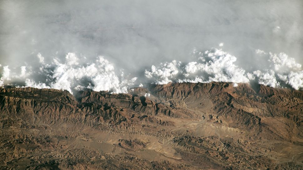 Earth from space: Wall of haze gets trapped behind mountains near ...