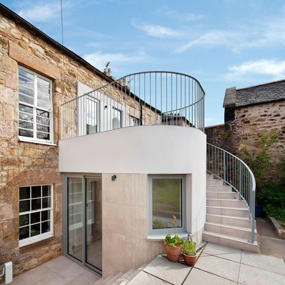 An extension with wrap-around outdoor staircase has reuinted this ...