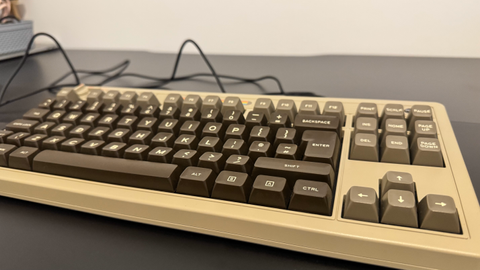 I use this retro-themed gaming keyboard with two big red programmable ...