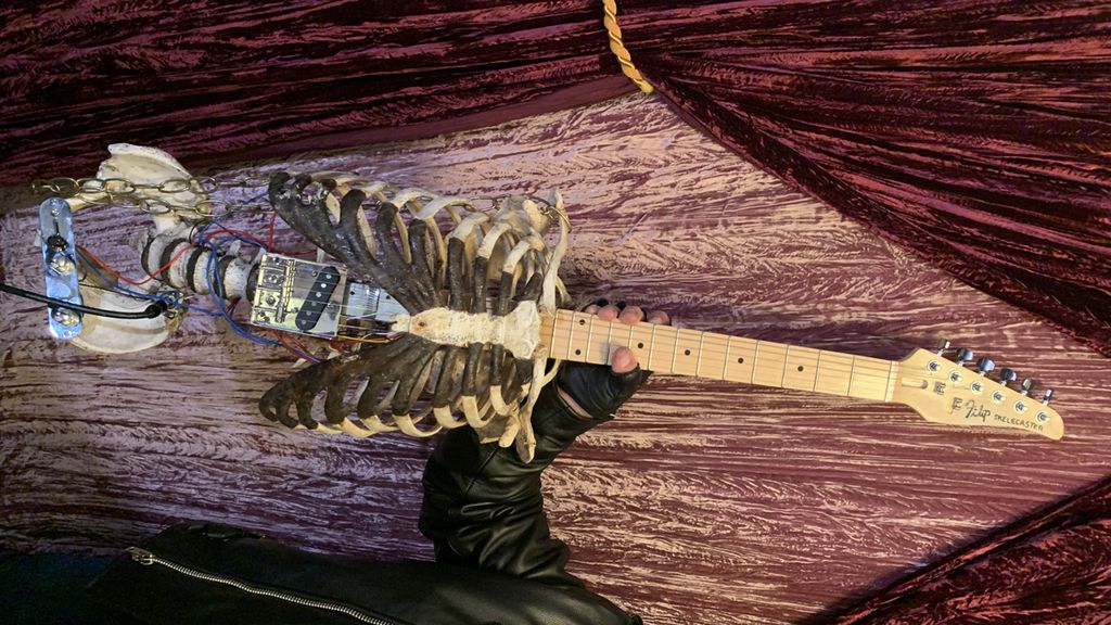 Man builds guitar out of uncle’s skeleton, uses it to play black metal ...