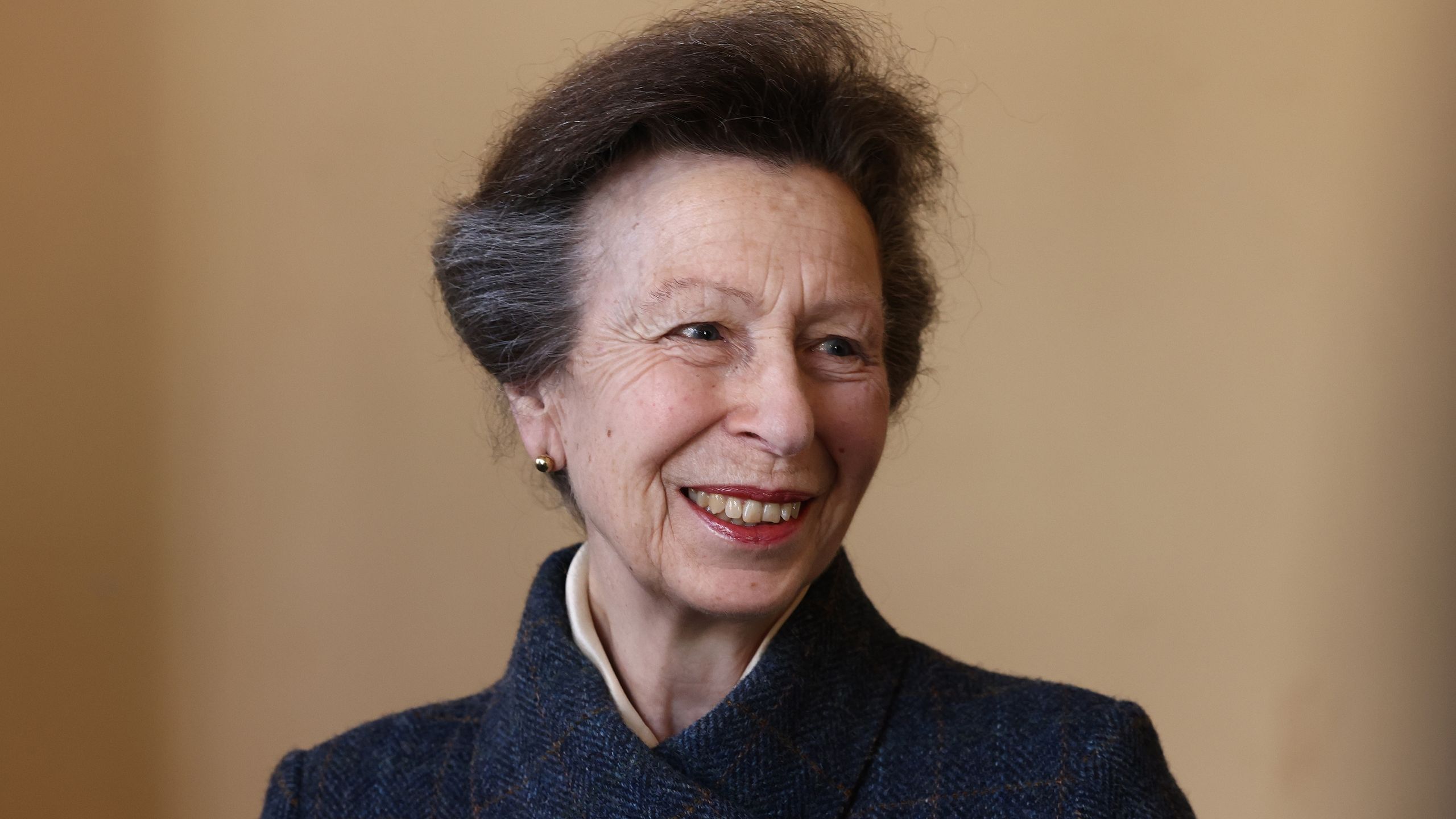 Princess Anne brings subtle festive touch to her oh-so chic checked co ...