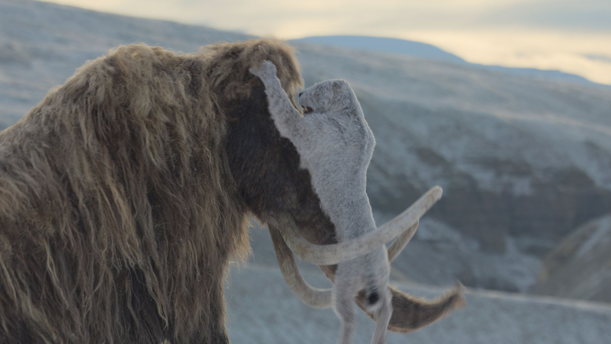 Woolly mammoths fight off attacking saber-toothed cats in stunning new ...
