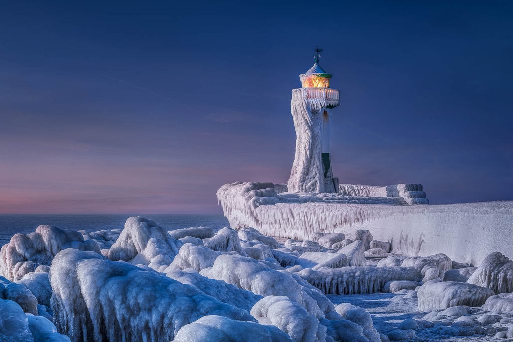 Stunning frozen lighthouse shot tops world’s largest photo competition ...
