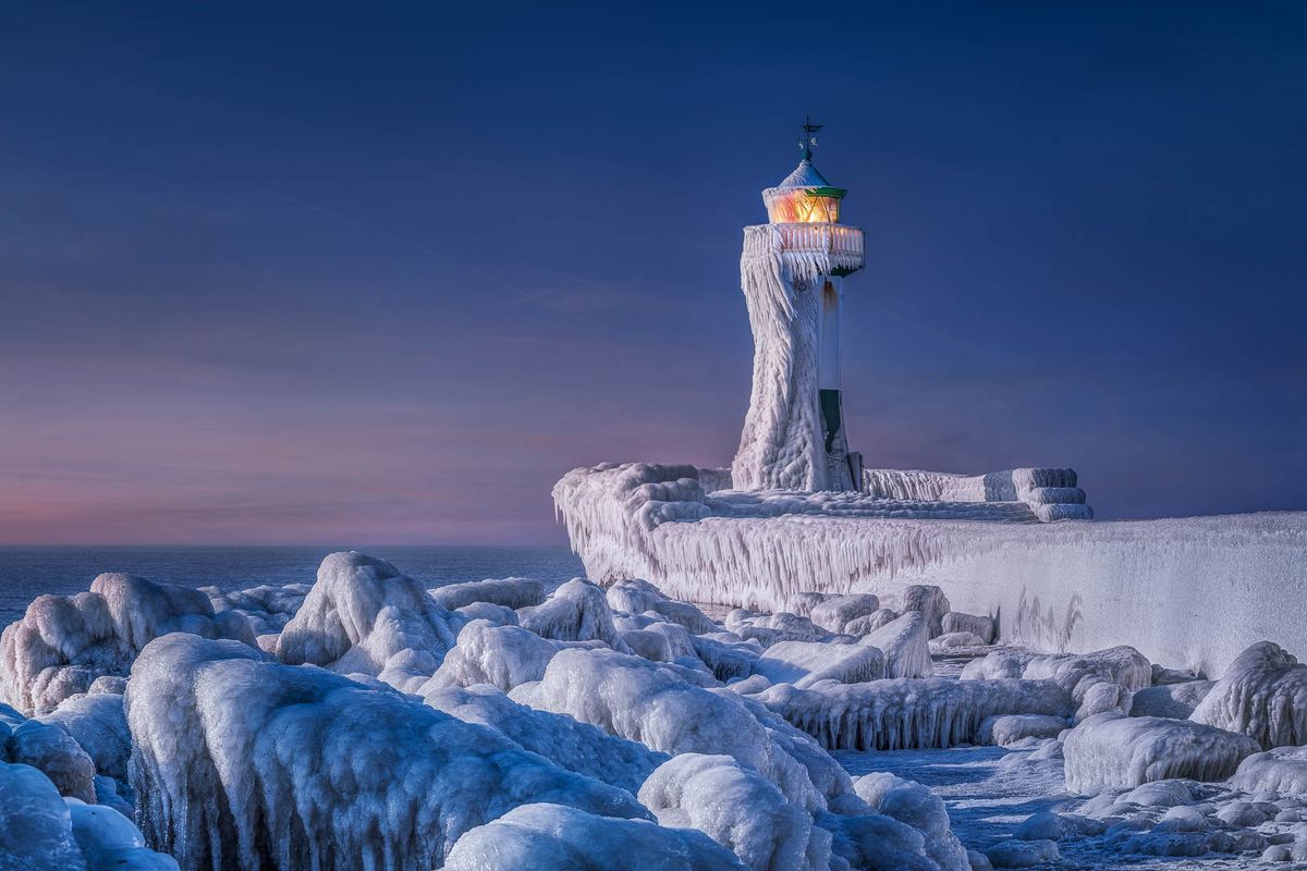 Stunning frozen lighthouse shot tops world’s largest photo competition ...