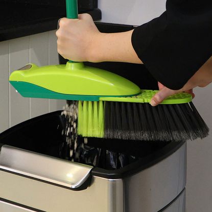 This genius Lakeland broom has a built-in vacuum to pick up dirt ...