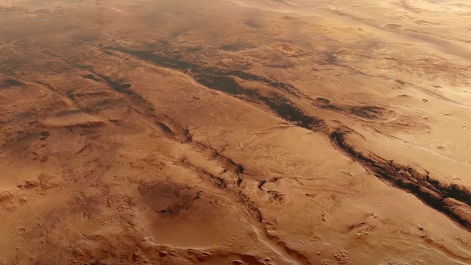 Fly over the scarred canyons of Mars in this breathtaking video from ...