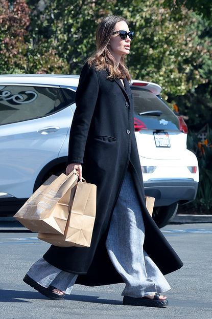Angelina Jolie Wore a Puddle-Pant Outfit With Platforms | Who What Wear