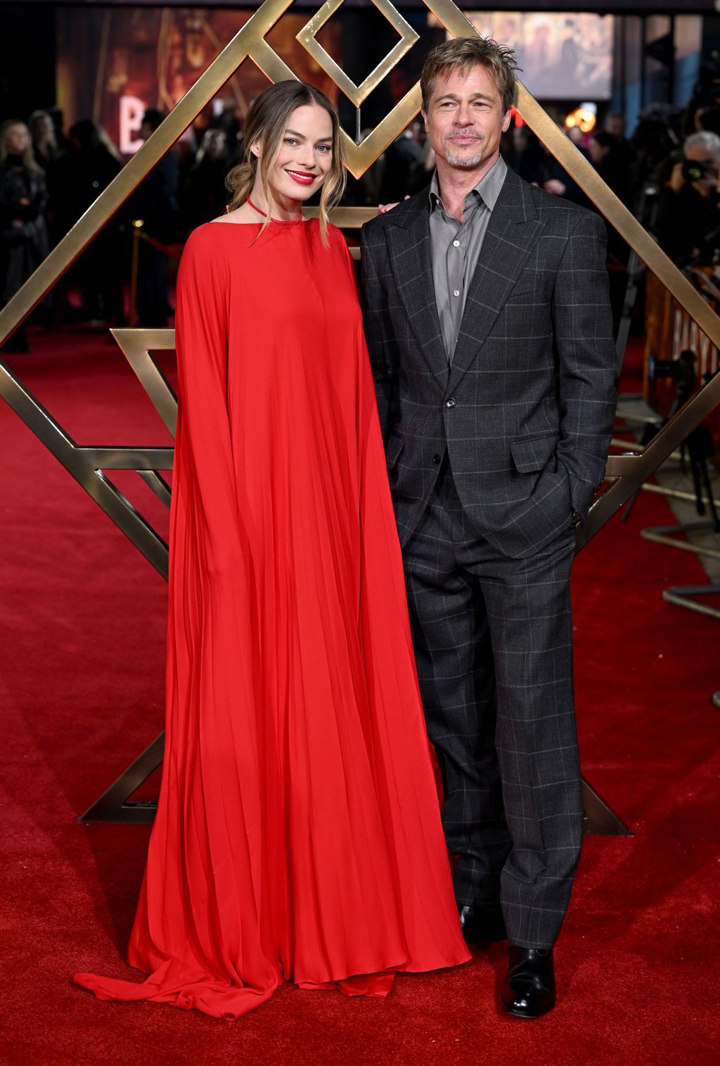 Margot Robbie Wore a Backless Caped Gown in London | Who What Wear