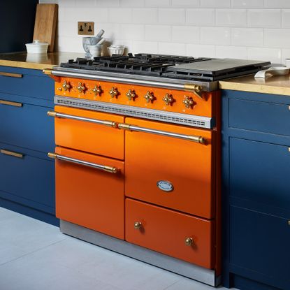 An orange range cooker was the inspiration for this kitchen | Ideal Home