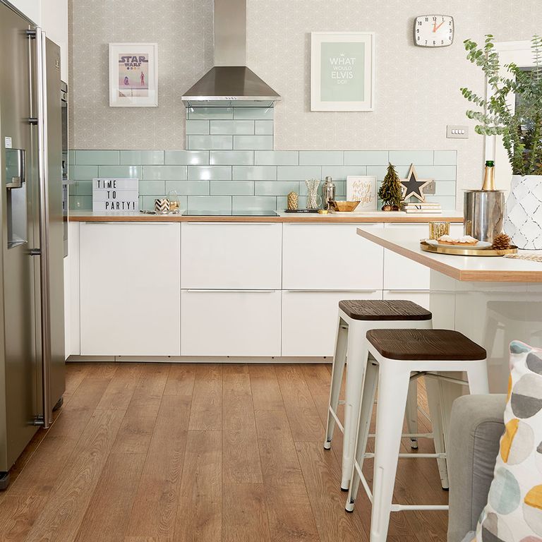 Open-plan kitchen with white gloss units and Scandi geometric wallpaper ...